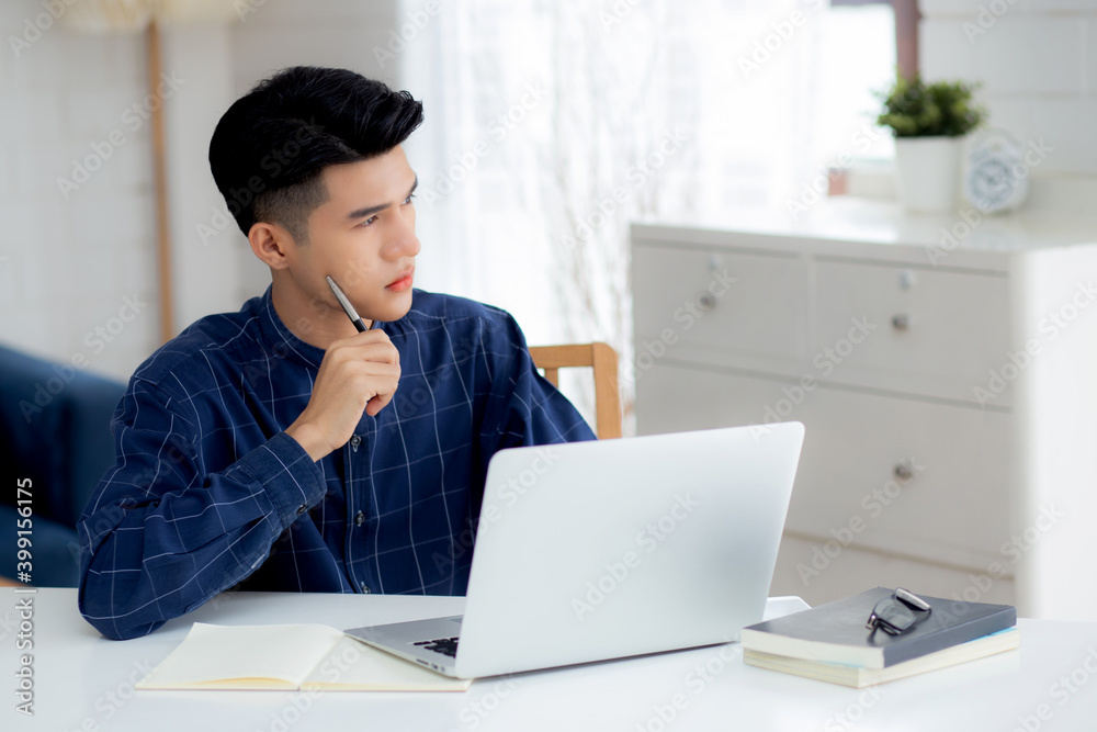 Young asian business man planning working and using laptop computer on ...
