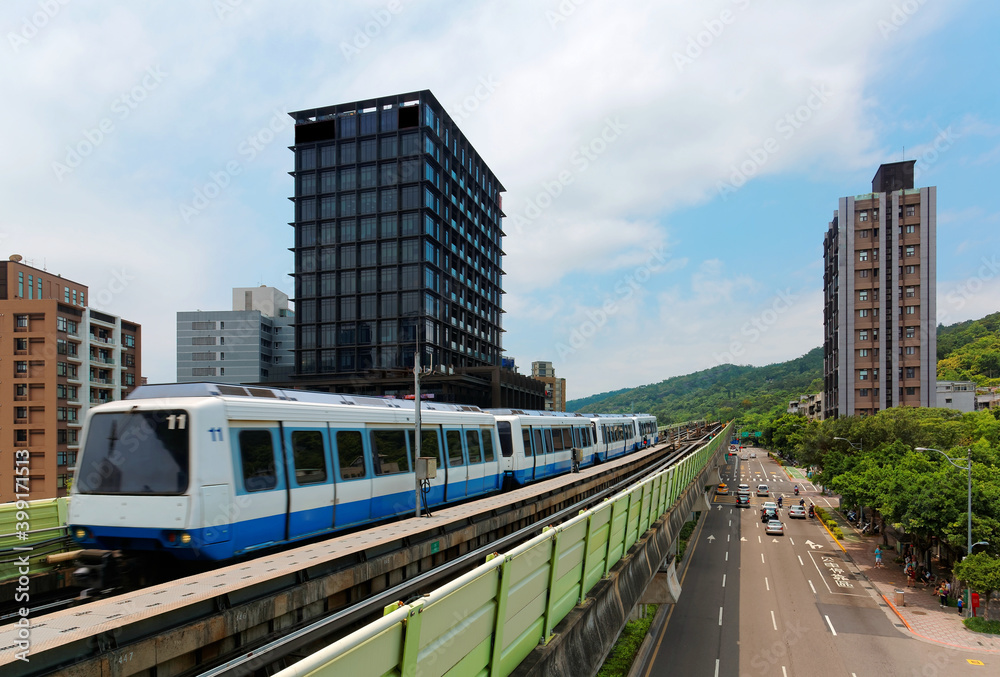 A metro train traveling on the elevated rails of Taipei MRT ( mass ...