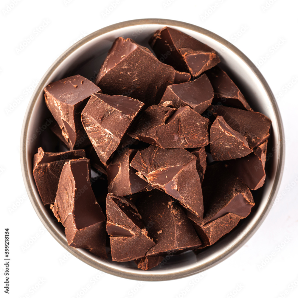 Dark chocolate chunks in a bowl isolated on white background ...