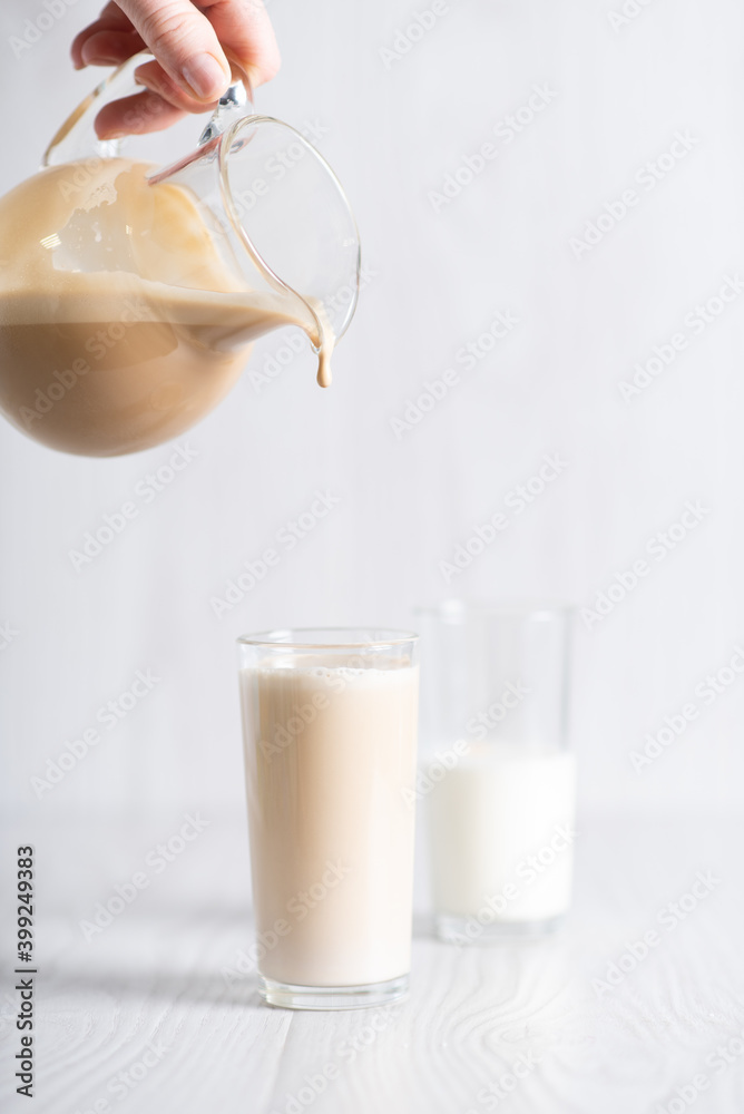 Dalgon brown coffee mixture is poured from the decanter into a glass of ...