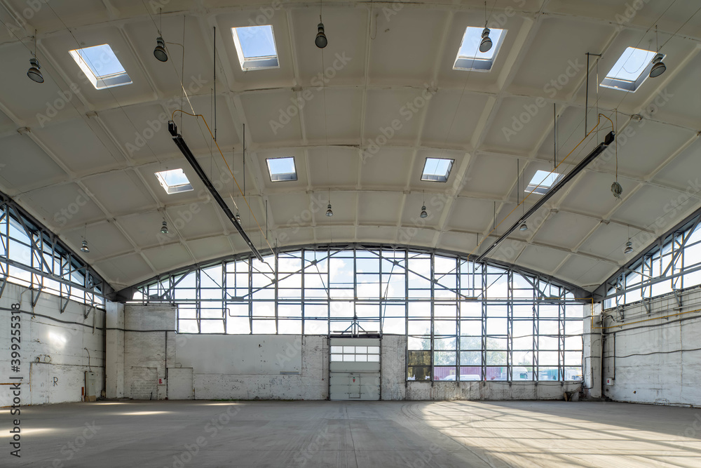Huge empty industrial warehouse. White interior. Unique architecture ...