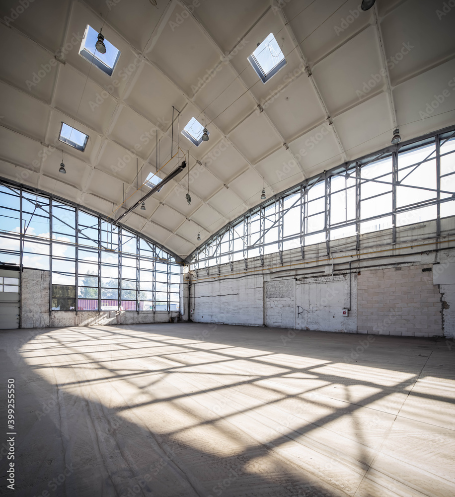 Huge empty industrial warehouse. White interior. Unique architecture ...