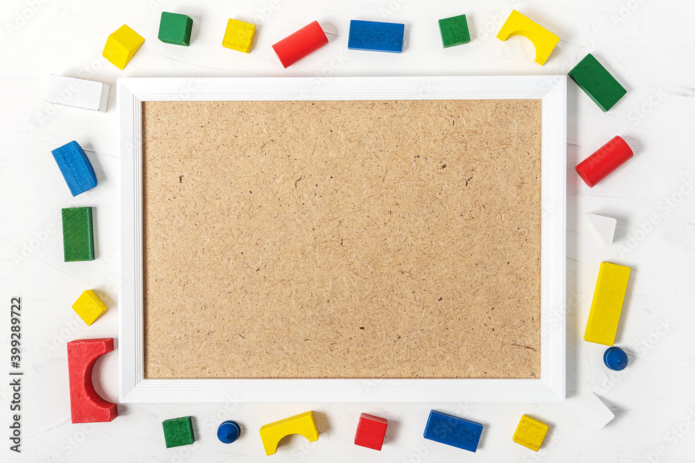 Colorful wooden blocks frame on white wooden background, top view with ...