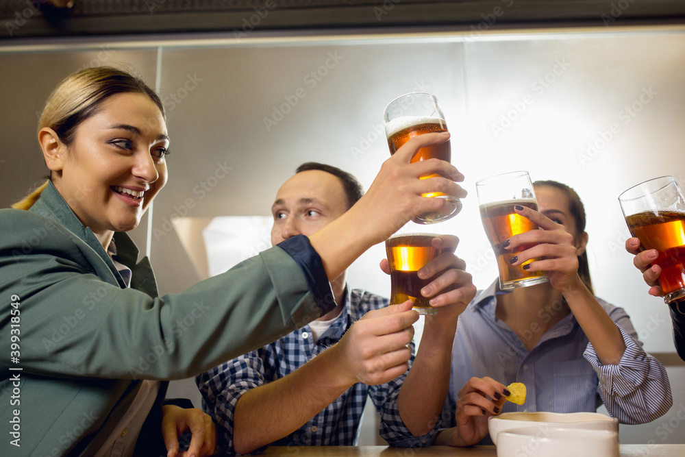 Clinking. Happy co-workers celebrating corporate event after tensioned ...