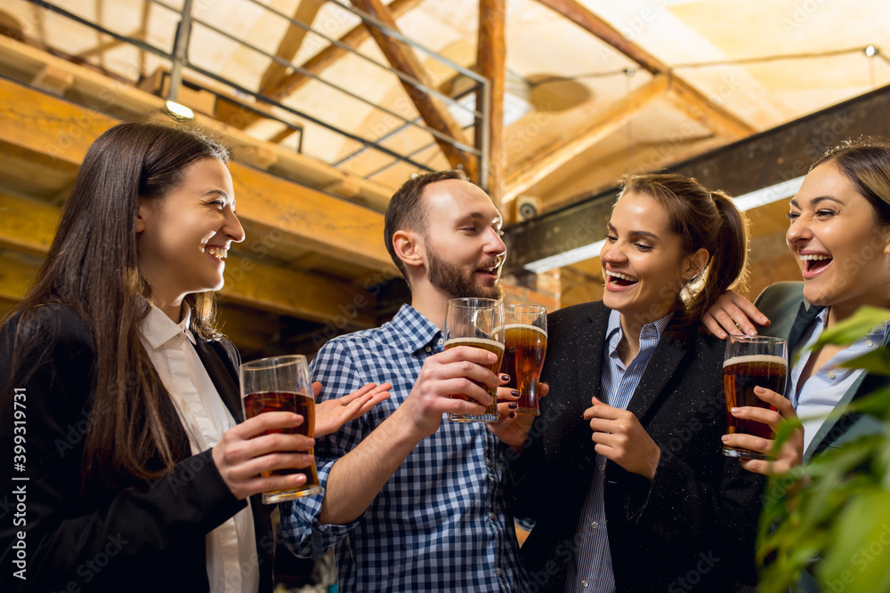 Having fun. Happy co-workers celebrating corporate event after ...