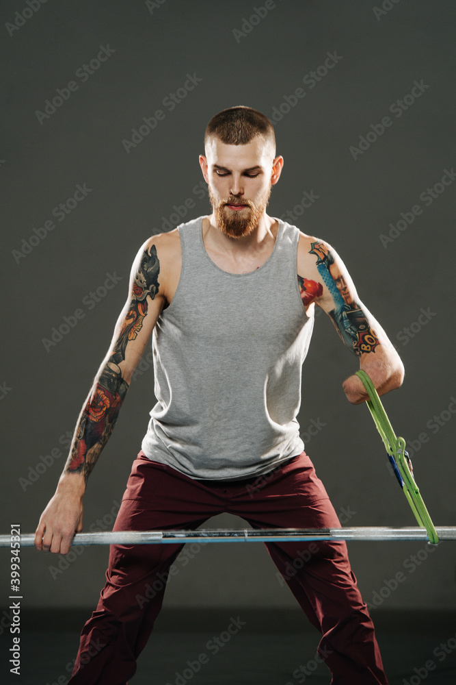 Determined disabled armless man training in the gym. Tackling barbell ...