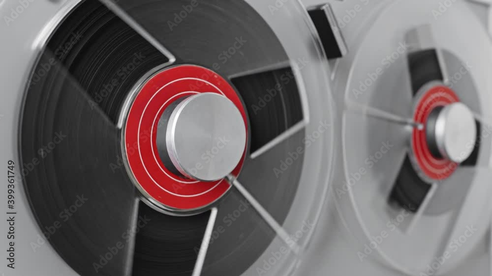 Reel to reel tape recorder playing. Rotating vintage music player close ...