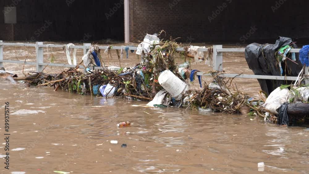 Close-up panning view of debris and plastic rubbish that wash up ...