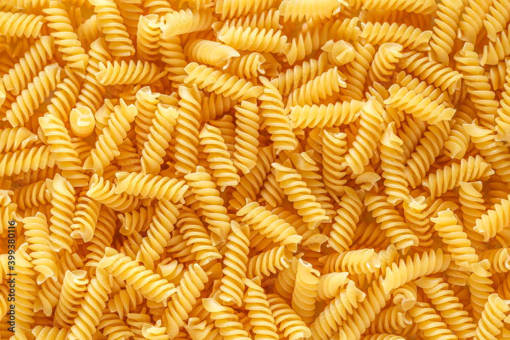Dry pasta fusilli. Fusilli have spiral shape and yellow color. Pasta is ...