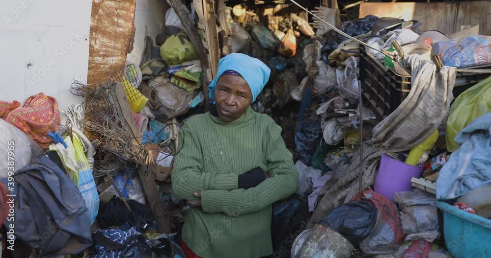 Face of poverty. Poor Black African woman sitting in-front of her house ...