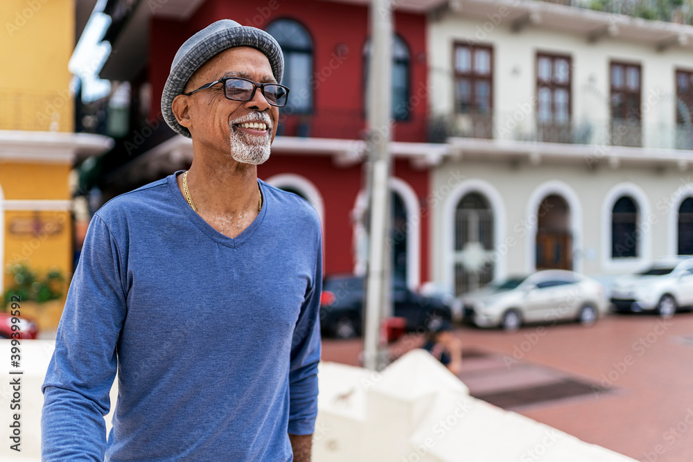 Senior black man walking down the street. Stock Photo | Adobe Stock