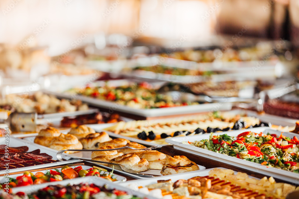 Elegant serving dishes and food warmers with various meals served for ...
