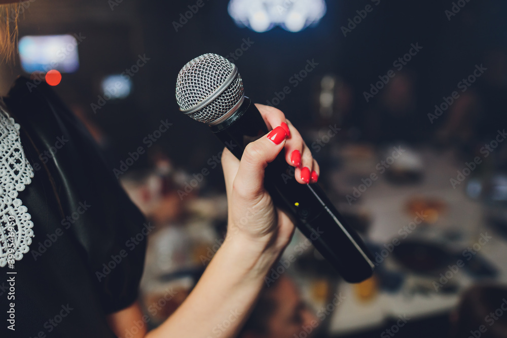 Microphone and unrecognizable female singer close up. Cropped image of ...