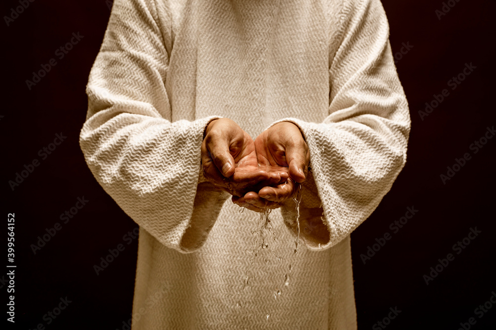 Water for Baptism pouring out of the hands of Jesus Christ during a ...