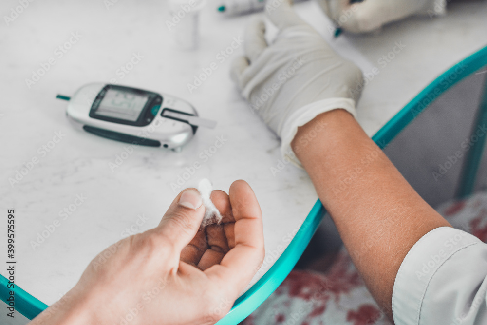 Blood glucose meter, glucometer and patient, the procedure takes place ...