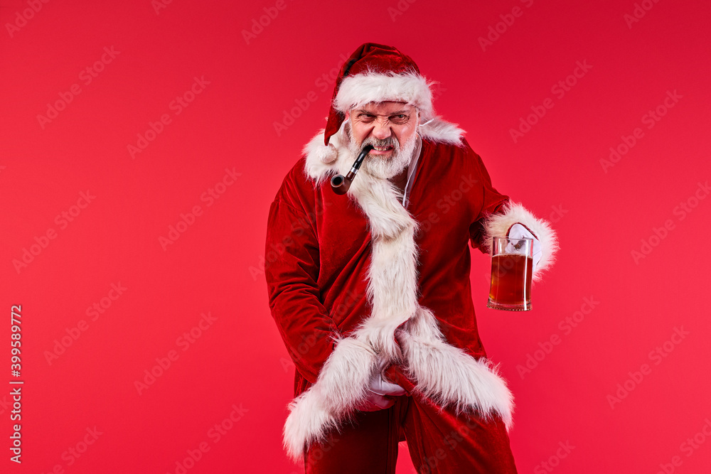 Bad Santa claus drinks alcohol, nasty party isolated over red studio ...