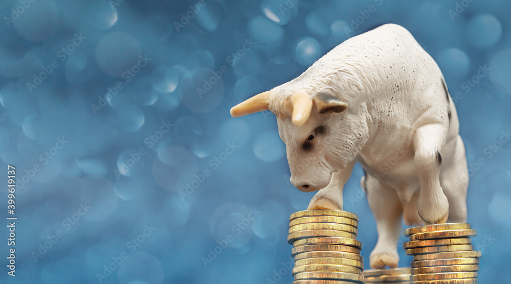 Miniature model of a bull standing on gold coins New Year's symbol 2021 ...