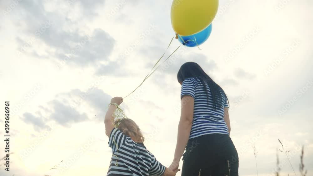 people in the park. happy family daughter and mom go strolling in with ...