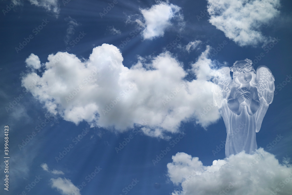 Little Angel in white clouds with light ray from heaven. religion ...