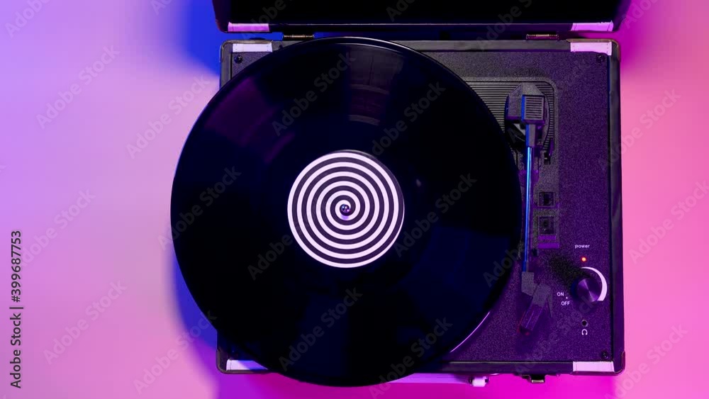 Top view of a music player with a spinning vinyl record against a ...