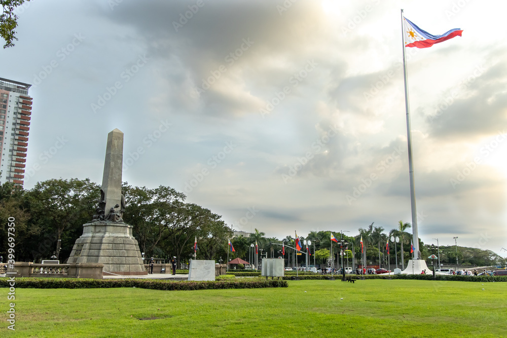 Dr. Jose Rizal National Monument and national flags in the wind, Manila ...