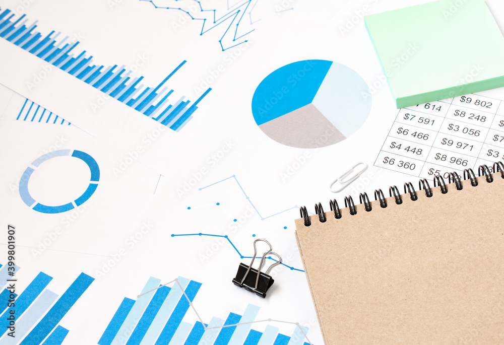 Office desk workplace with pc, paper charts or graph and notebook and ...