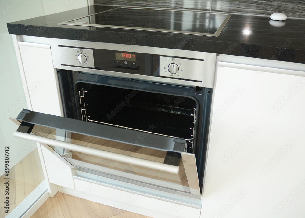 A close-up on a black radiant electric cooktop, electric ceramic glass ...