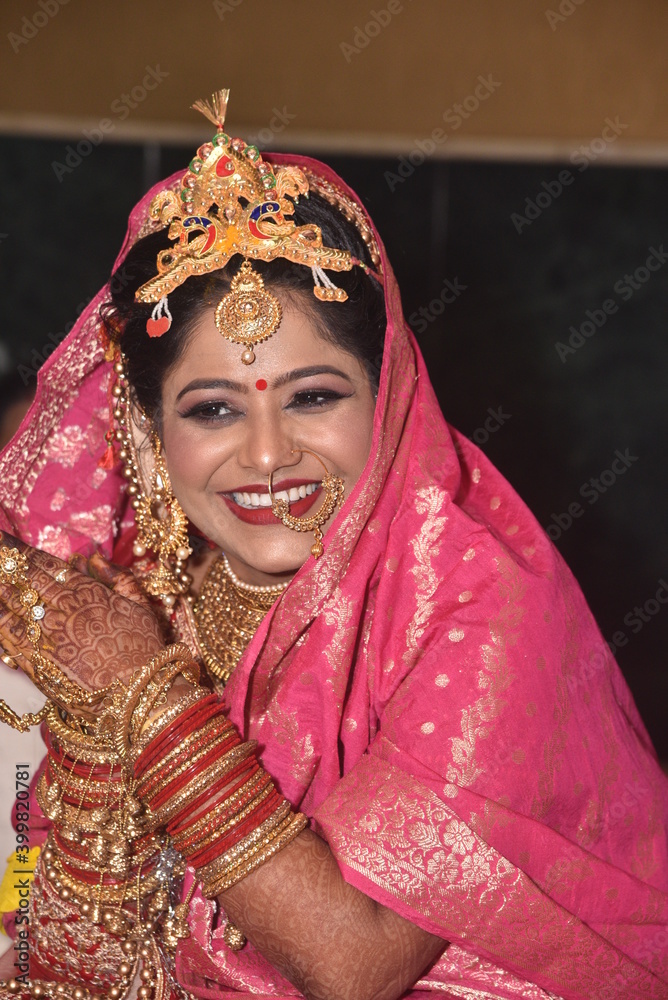 : Cute Indian Bride laughing during her wedding ceremony. She is ...