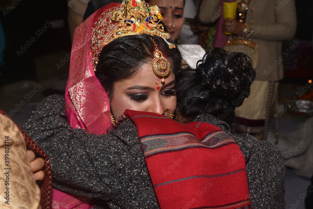 Bride crying during the vidai ceremony. She is hugging her mother ...