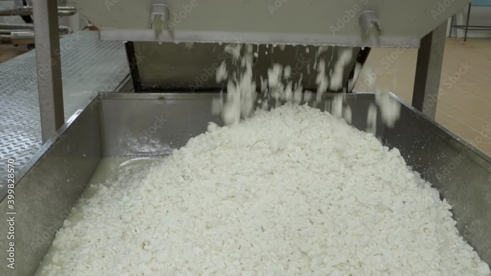 Cottage cheese curds and whey is falling out from the ending of a ...