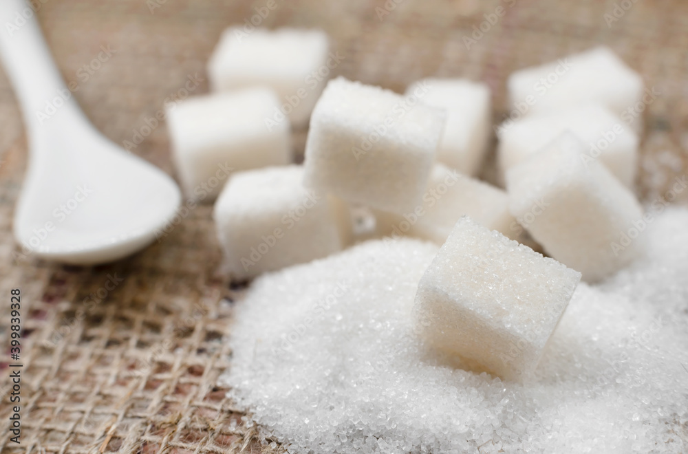 Pieces of lump sugar on burlap. granulated sugar close-up. Refined ...