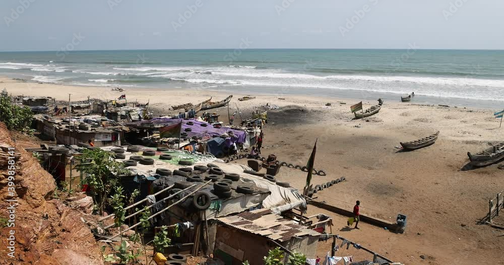 Accra Ghana fishing boats poor shacks on ocean 4K. Historic ancient ...