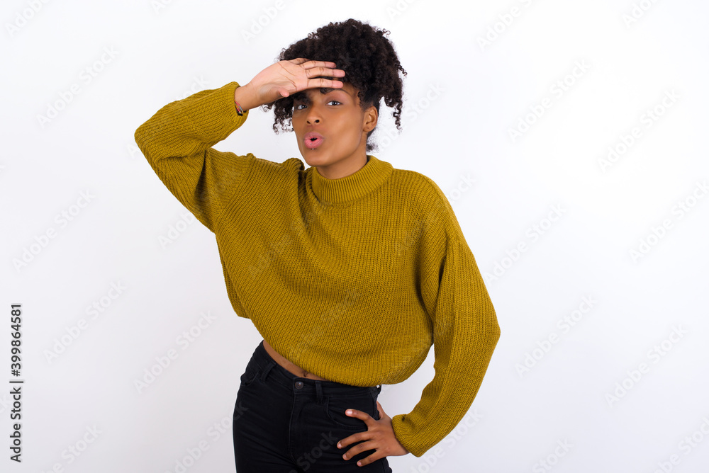 Young beautiful African American woman wearing knitted wiping forehead ...