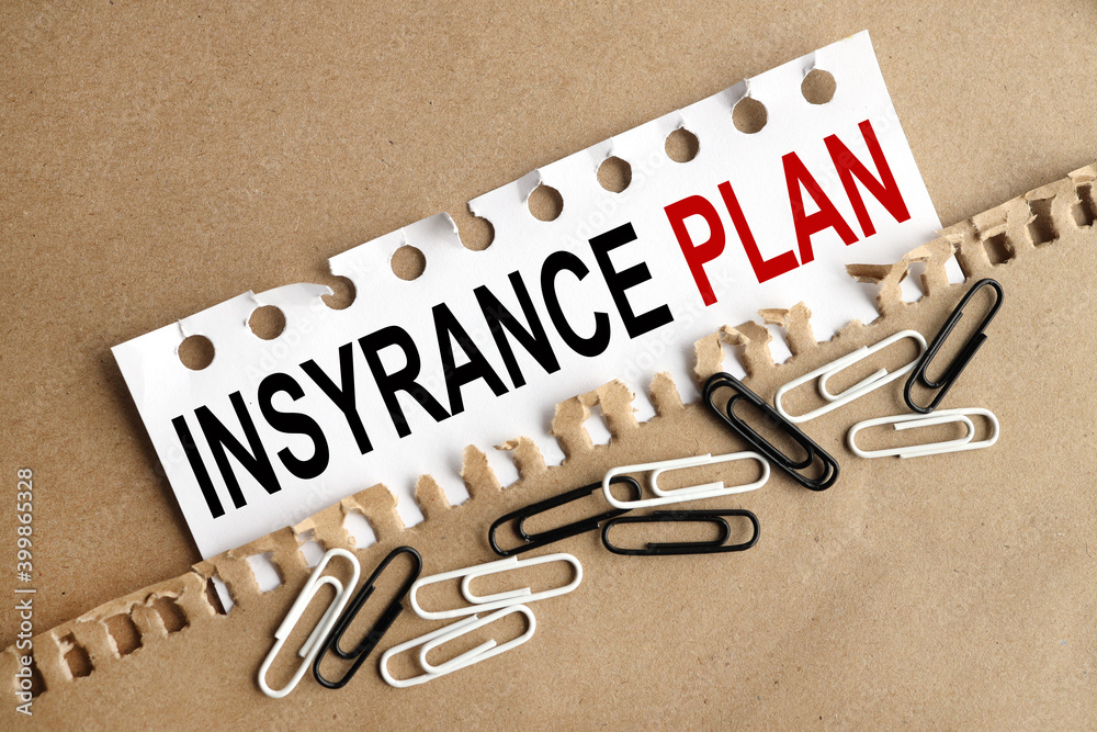 INSURANCE PLAN, text on white paper with torn paper background. near ...