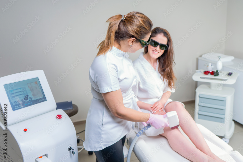 woman in professional beauty clinic during laser hair removal ...