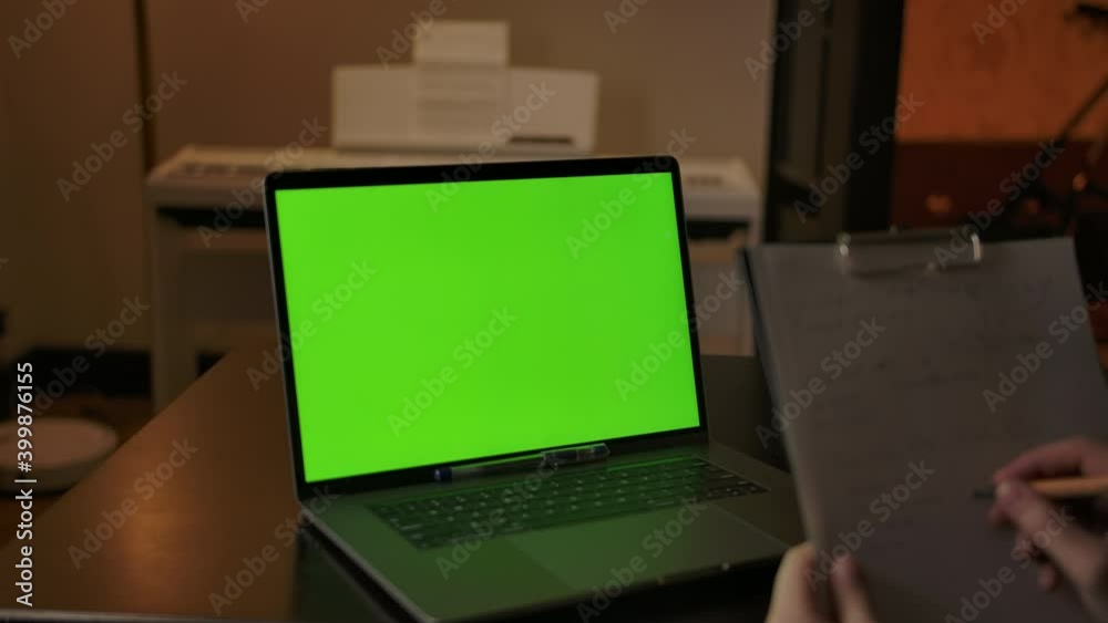Writing scientific notes behind green screen laptop at home. Ready for ...