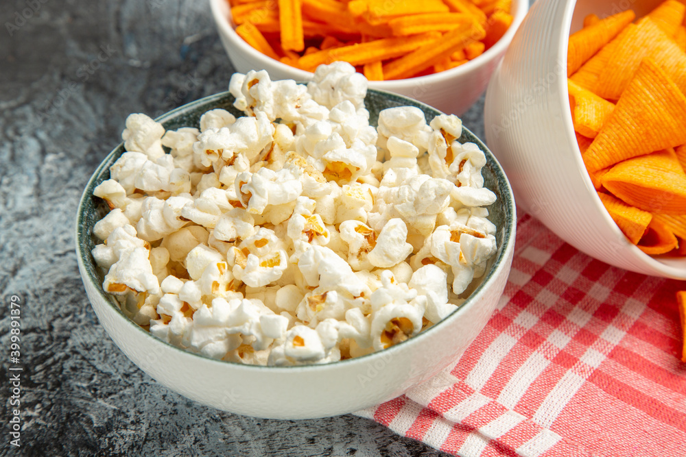 front view cheese cips with rusks and popcorn on the light background ...