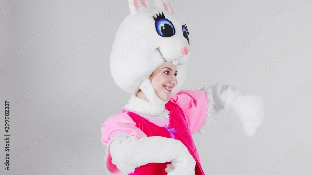 Portrait of a young cute girl in a beautiful hare costume isolated on ...