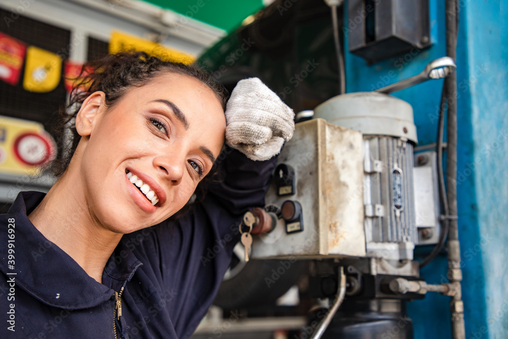 Beautiful woman mechanics in uniform is working in auto service with ...