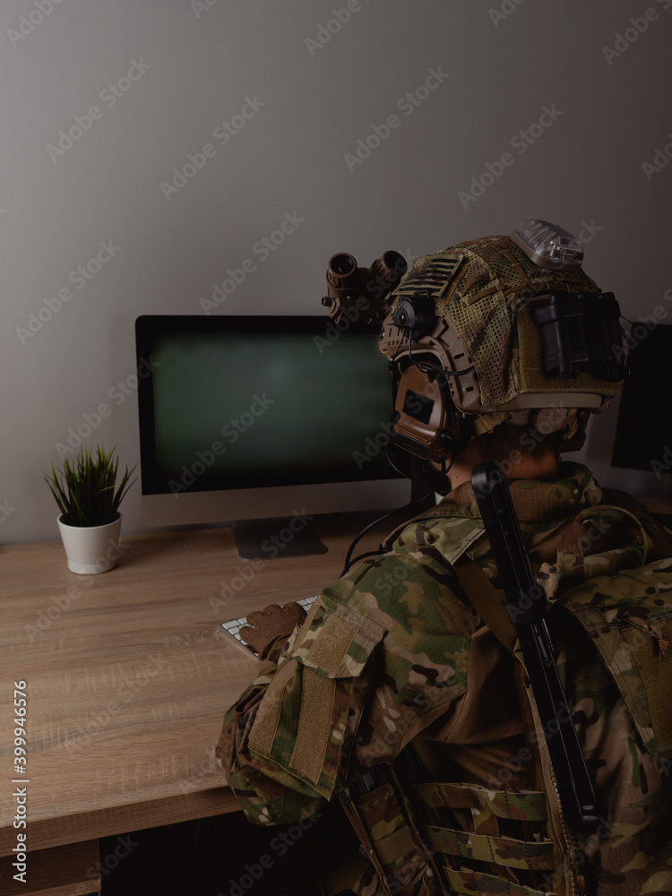 US Army special forces operator looking at the computer screen in the ...