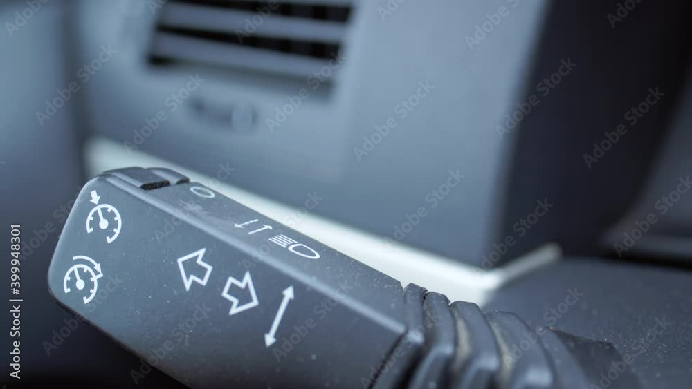 Male driver using turn signal switch. Turning on the right car turn ...