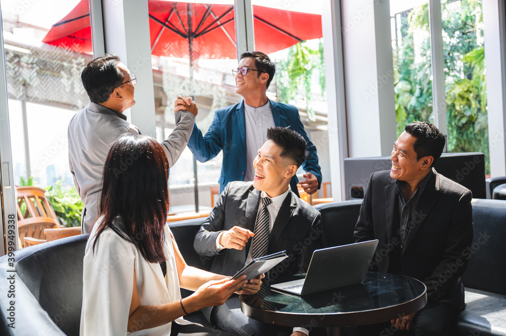 Group of young Asian business people celebrate success with raise hand ...