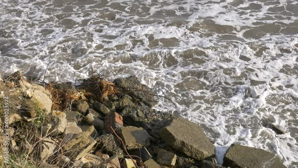 Ocean Waves Splashing On Pile Of Old Damaged Concrete Blocks And Debris ...