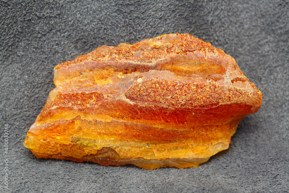 Yellow amber with inclusions on a dark background. Natural mineral from ...