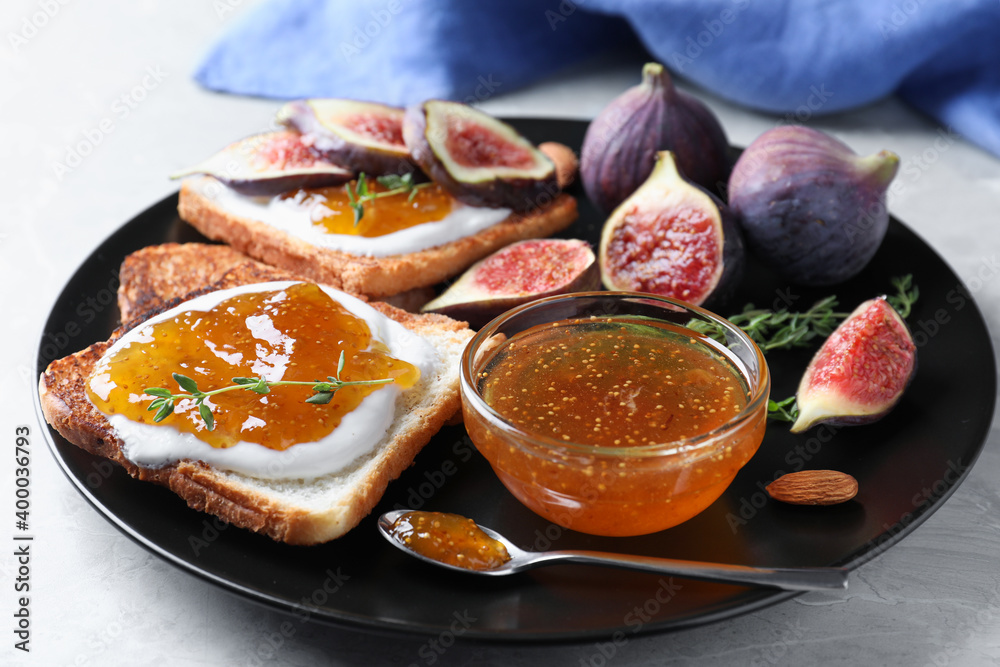Tasty toasts with fig jam and cream cheese on grey table, closeup Stock ...