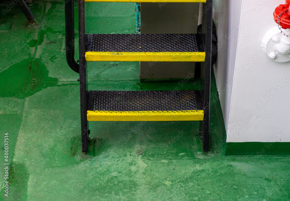 Steps and stairs on board offshore ship marked with yellow black ...