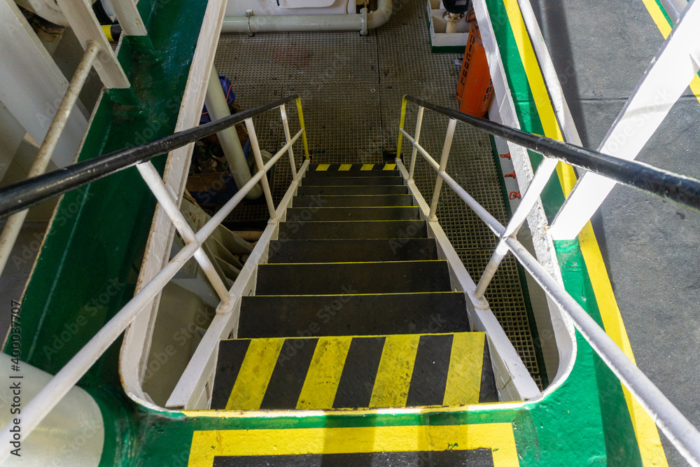 Steps and stairs on board offshore ship marked with yellow black ...