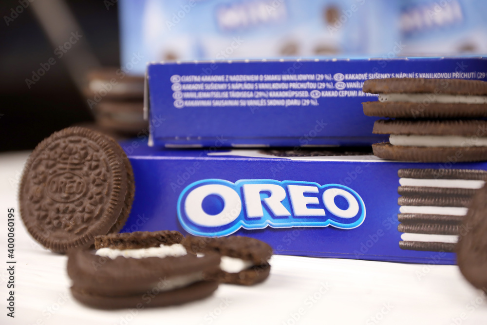 Oreo sandwich cookies and blue product boxes on white table. Oreo is a ...