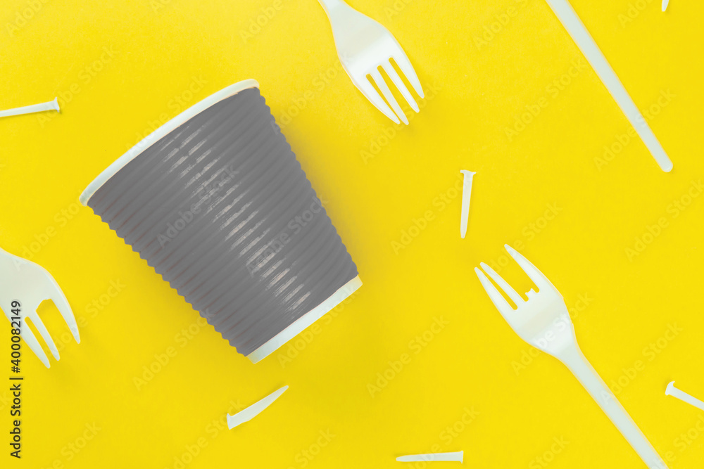 Pattern of a lot of broken plastic forks, and grey plastic cup on a ...