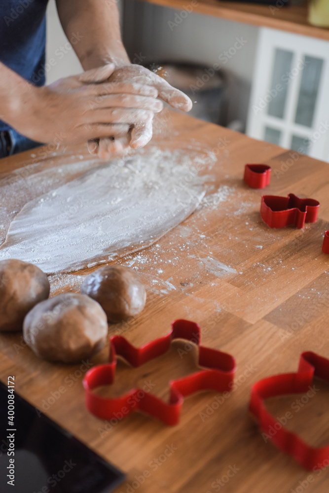 Handsome man with glasses is making homemade spicy cookies with raw ...